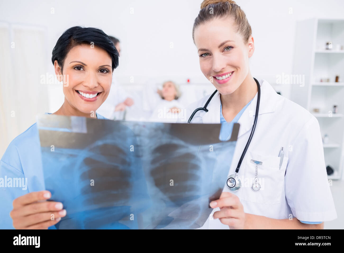Portrait of a doctor and surgeon visiting female patient in the ...