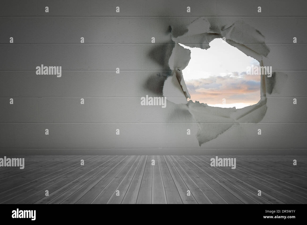 Rip on wall showing bright sky Stock Photo - Alamy