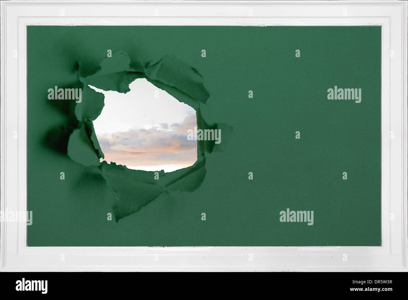 Rip on wall showing bright sky Stock Photo - Alamy