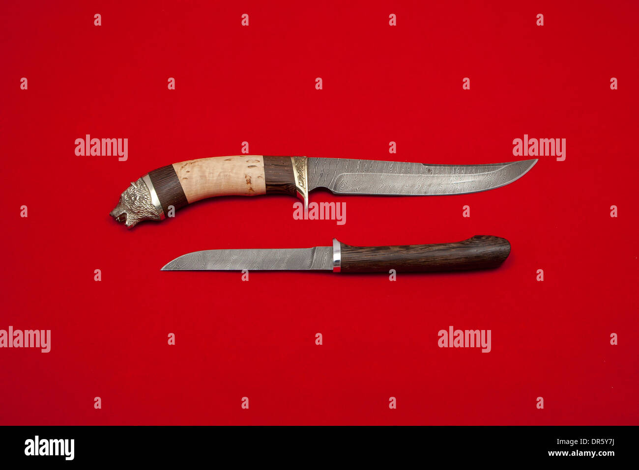 Two knives on red Stock Photo - Alamy