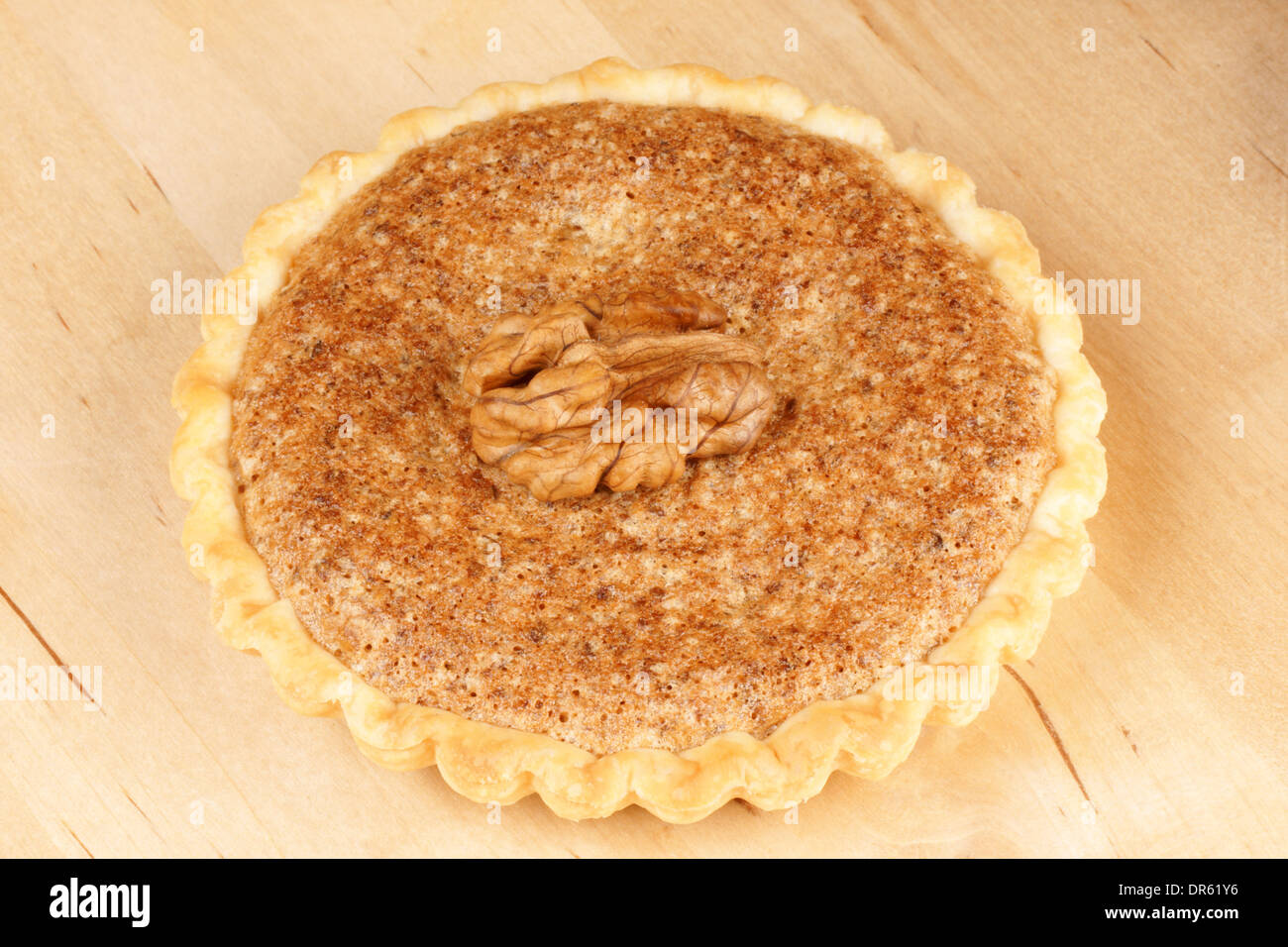 Close-up of a mini walnut tart over a wooden background Stock Photo - Alamy