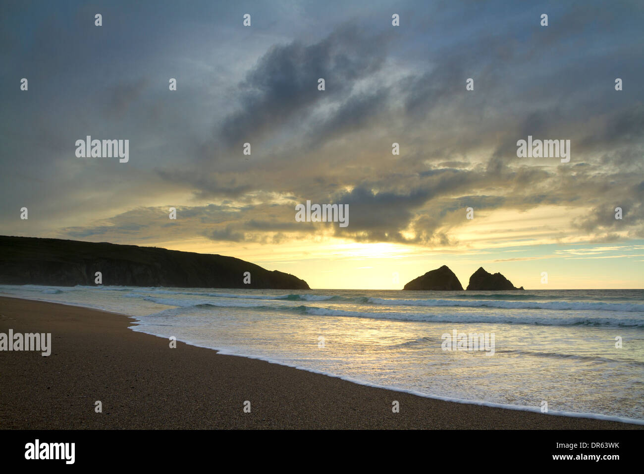 sunset with surfers in the water at holywell bay, newquay UK Stock ...