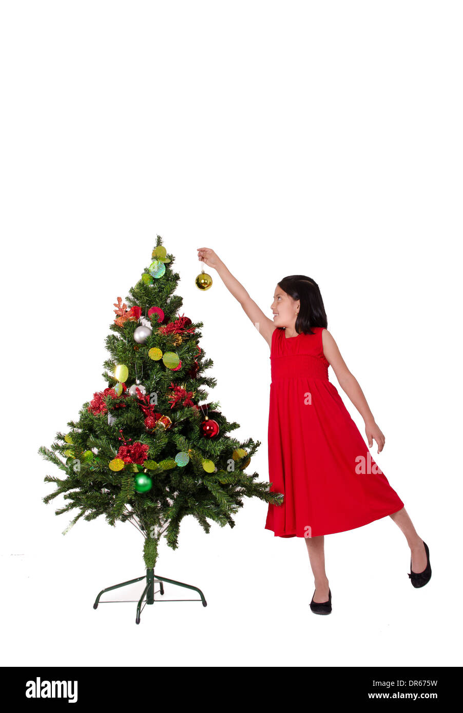 little girl decorating a Christmas tree Stock Photo - Alamy