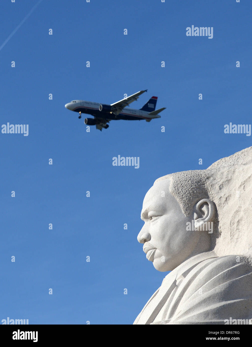 Washington DC, USA. 20th Jan, 2014. A plane flies over the statue of ...