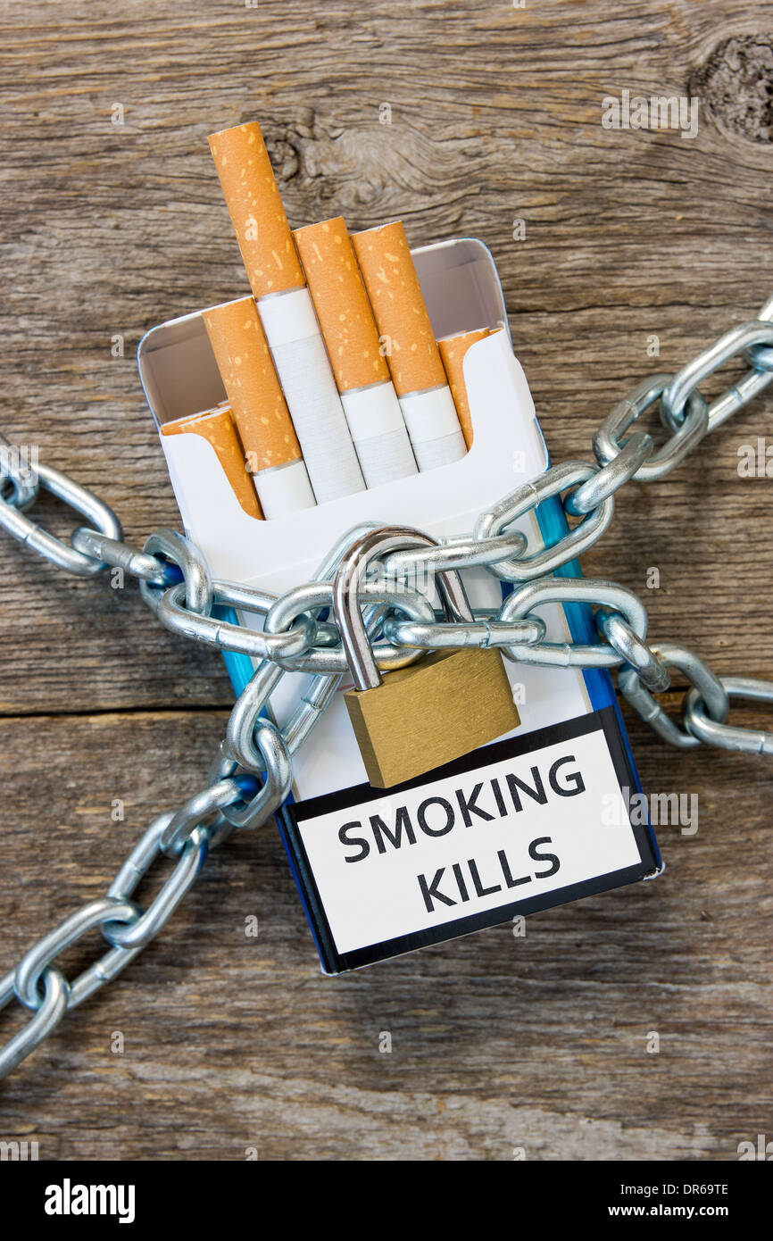 Pack of cigarettes and a padlock with chain Stock Photo - Alamy