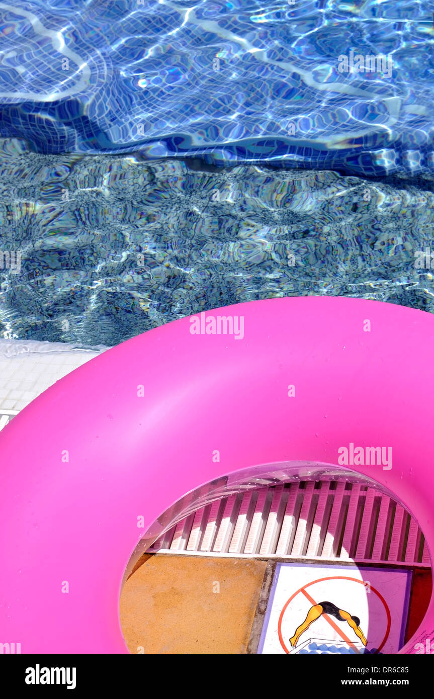 Floating tire beside a swimming pool Stock Photo - Alamy