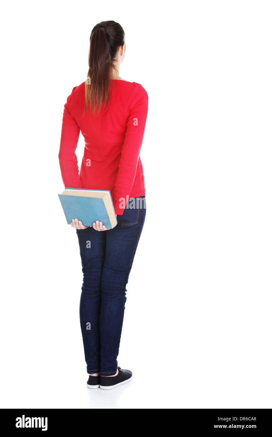 Back view of young student woman holding an old book. Isolated over ...