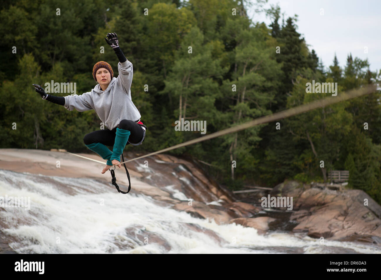 Female slackliner standing up on a slackline that spans a river Stock ...