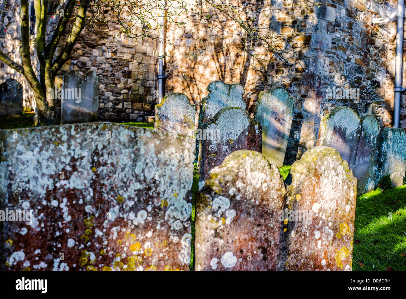 Old gravestones in Medieval graveyard in colourful afternoon light ...
