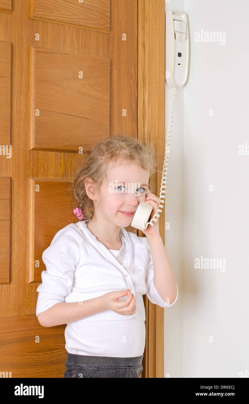 Little girl talking on the intercom at home Stock Photo - Alamy