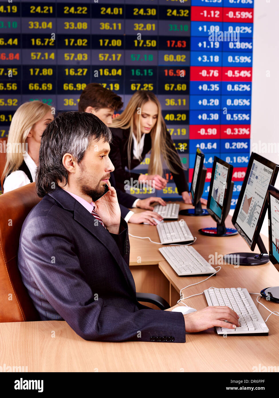 Group business people with stock exchange board in office Stock Photo ...