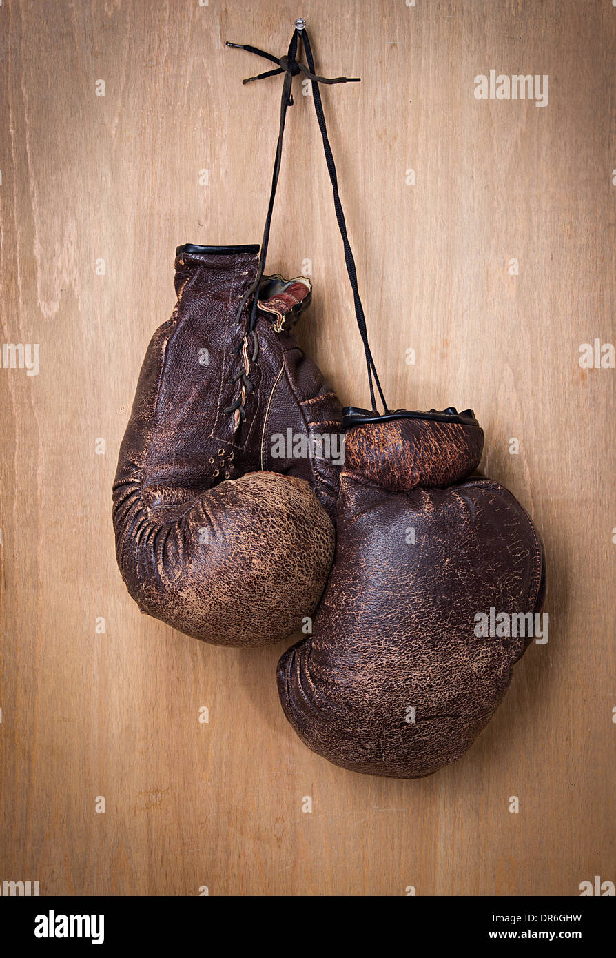 old boxing gloves hang on nail on wall Stock Photo - Alamy