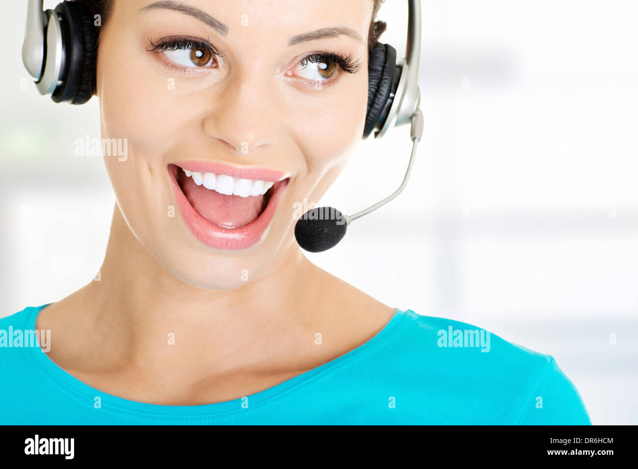 Beautiful young call-center assistant smiling , isolated Stock Photo ...