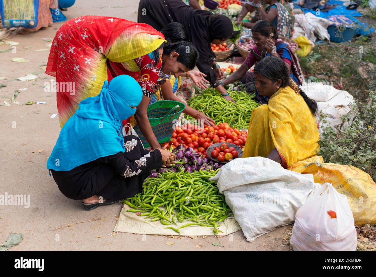 Indian women buying vegetables from a street market in Puttaparthi ...