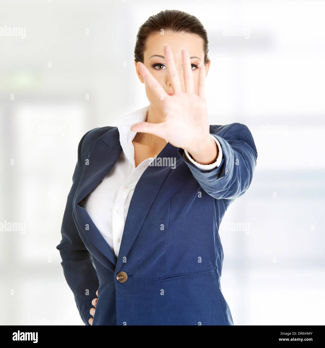 Serious business woman making stop sign over white Stock Photo - Alamy