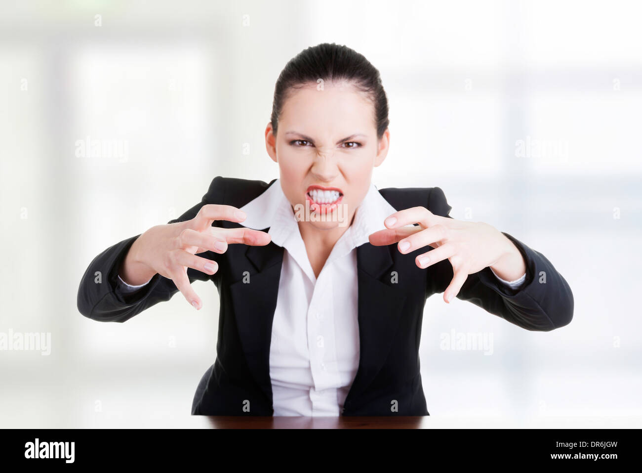 Angry businesswoman at the desk, isolated on white background Stock ...