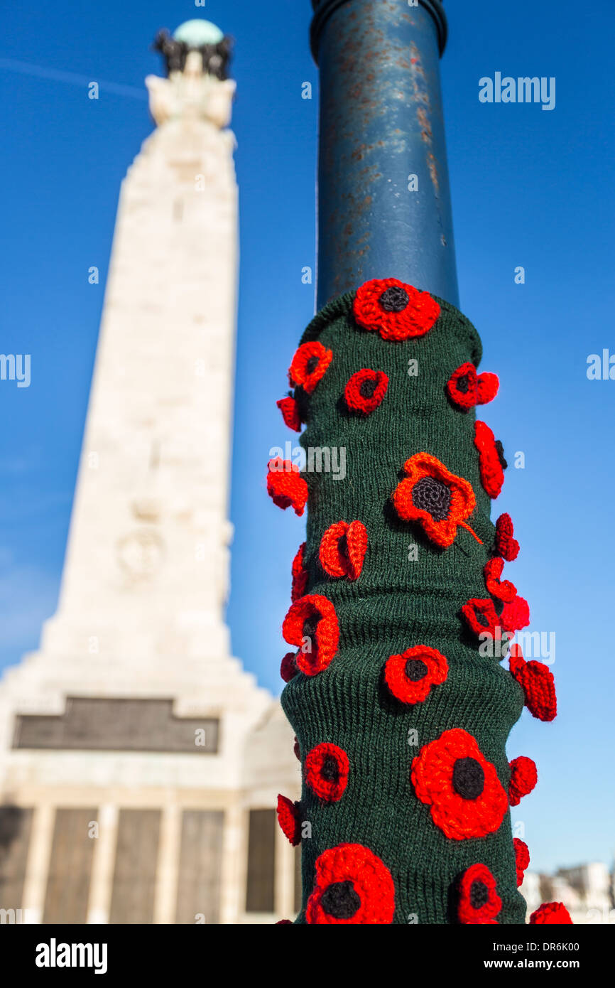 Hand crochetted and knitted red poppies on lamp post in front of the ...