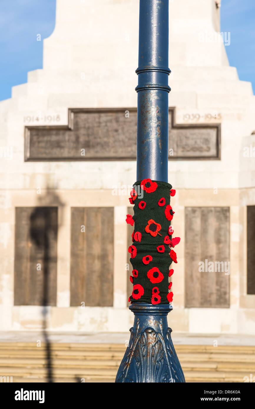 Hand crocheted and knitted red poppies on lamp post in front of the ...