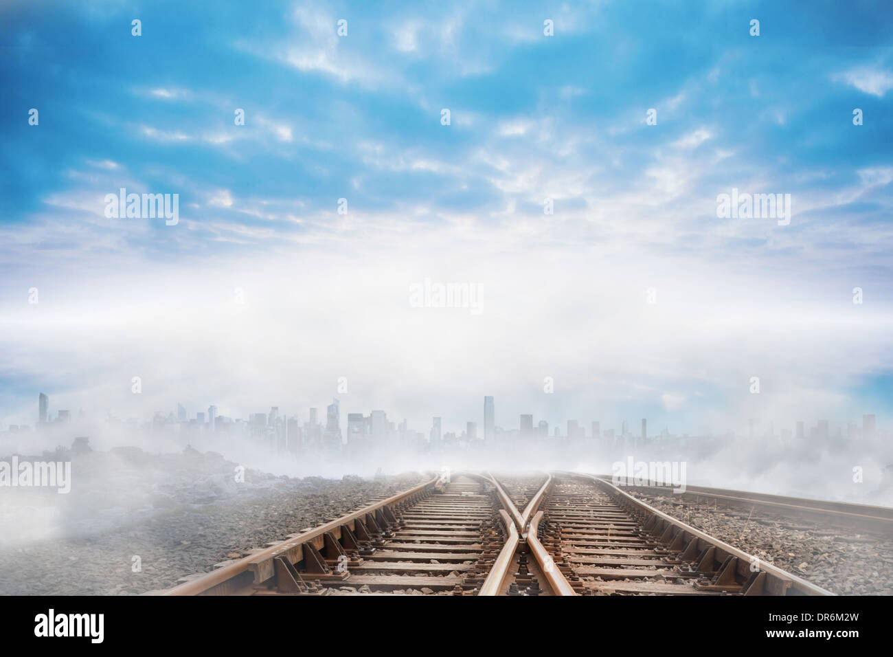 Train tracks leading to city on the horizon Stock Photo - Alamy