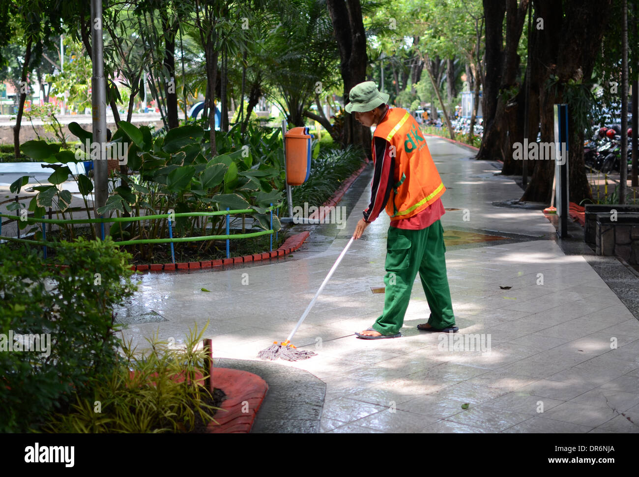 A janitor cleaning and caring for Bungkul Park - The Best City Park In ...