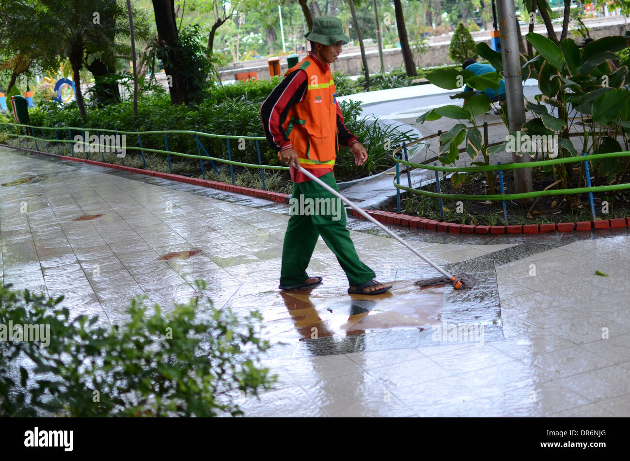 A janitor cleaning and caring for Bungkul Park - The Best City Park In ...