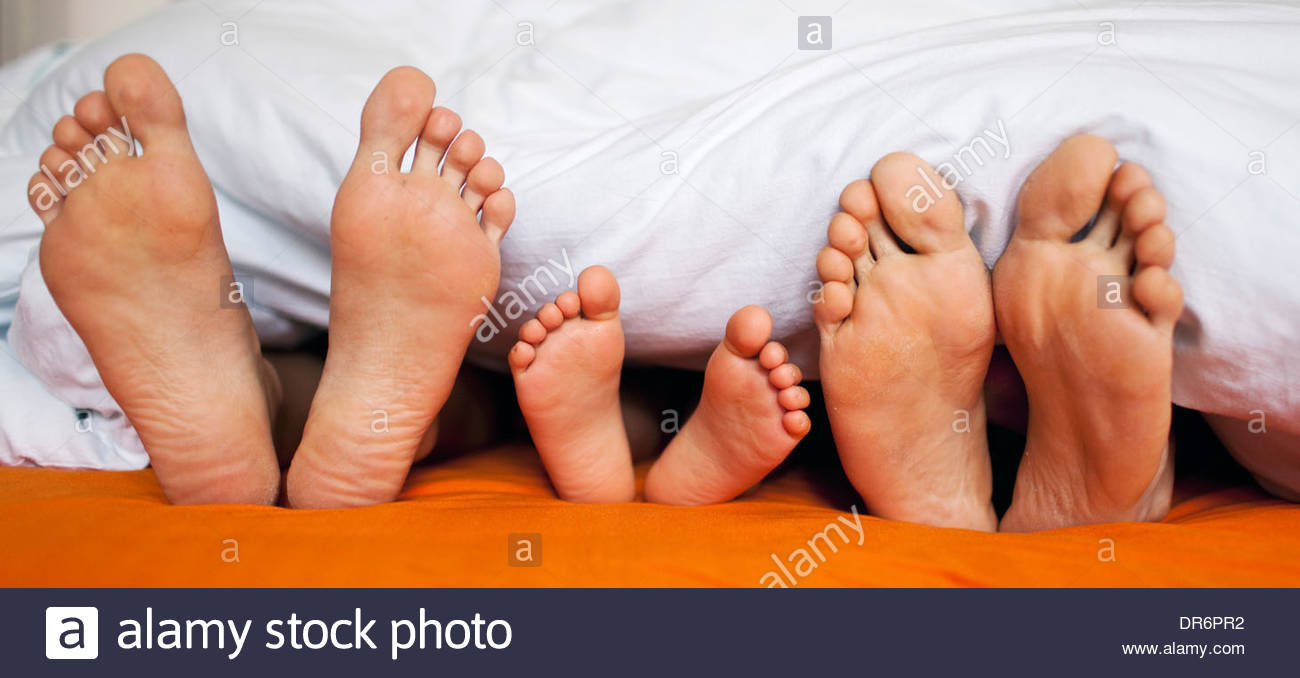 Family Of Three People Sleeping In One Bed Stock Photos & Family Of ...