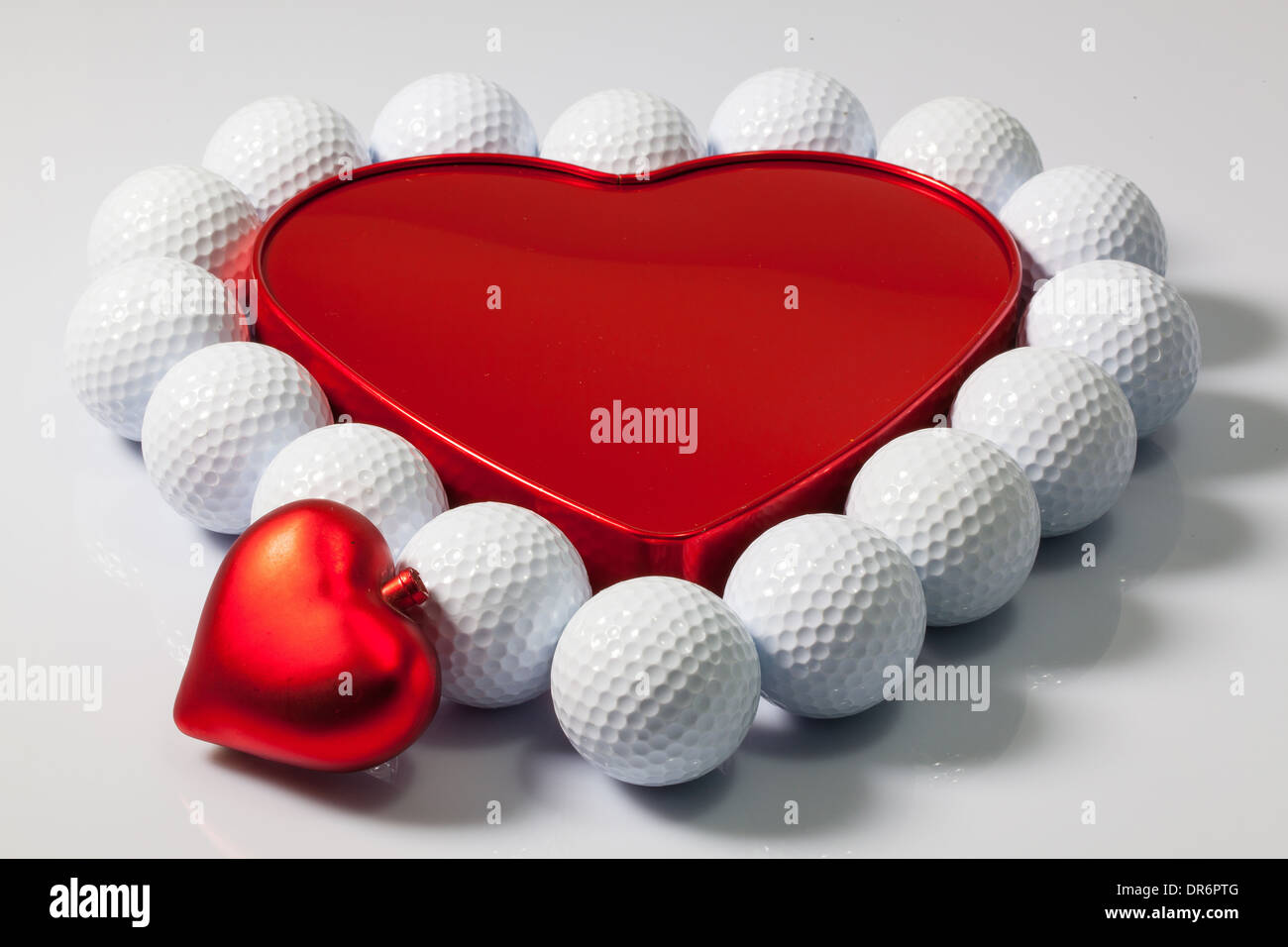 Heart of white golf balls Stock Photo - Alamy