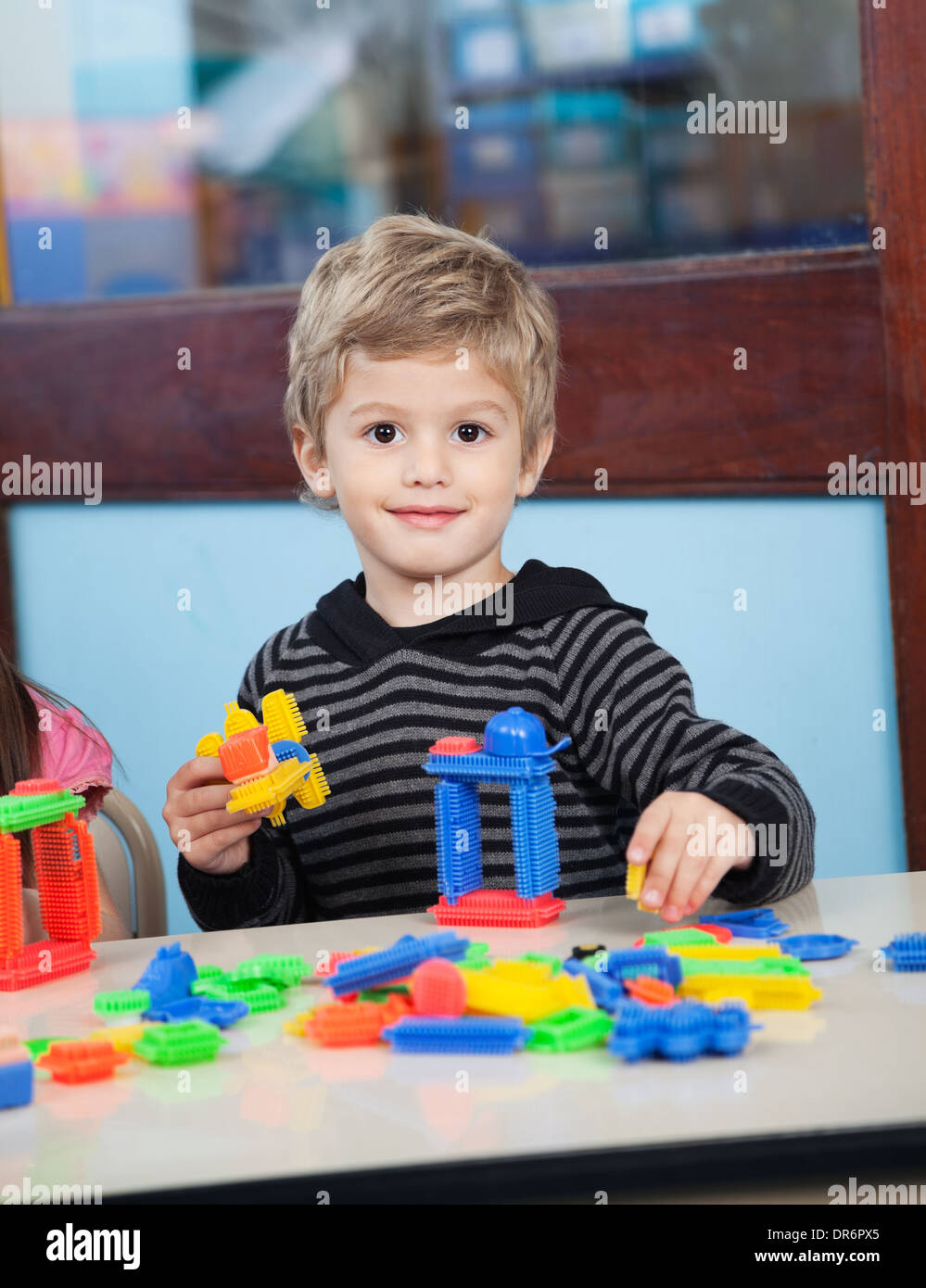 Boy Playing With Blocks In Kindergarten Stock Photo - Alamy