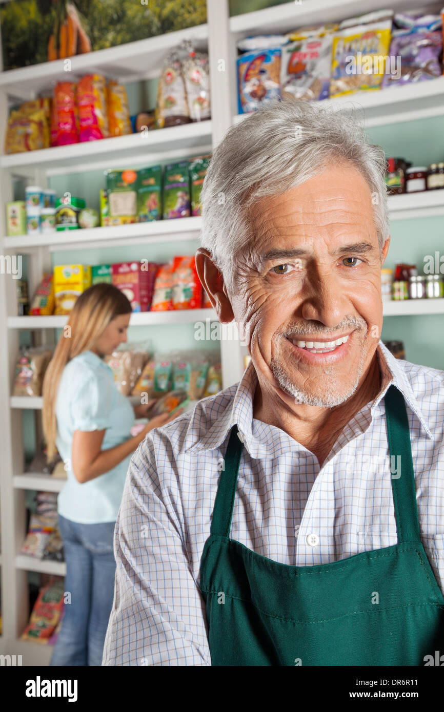 Owner With Female Customer Shopping In Background Stock Photo - Alamy