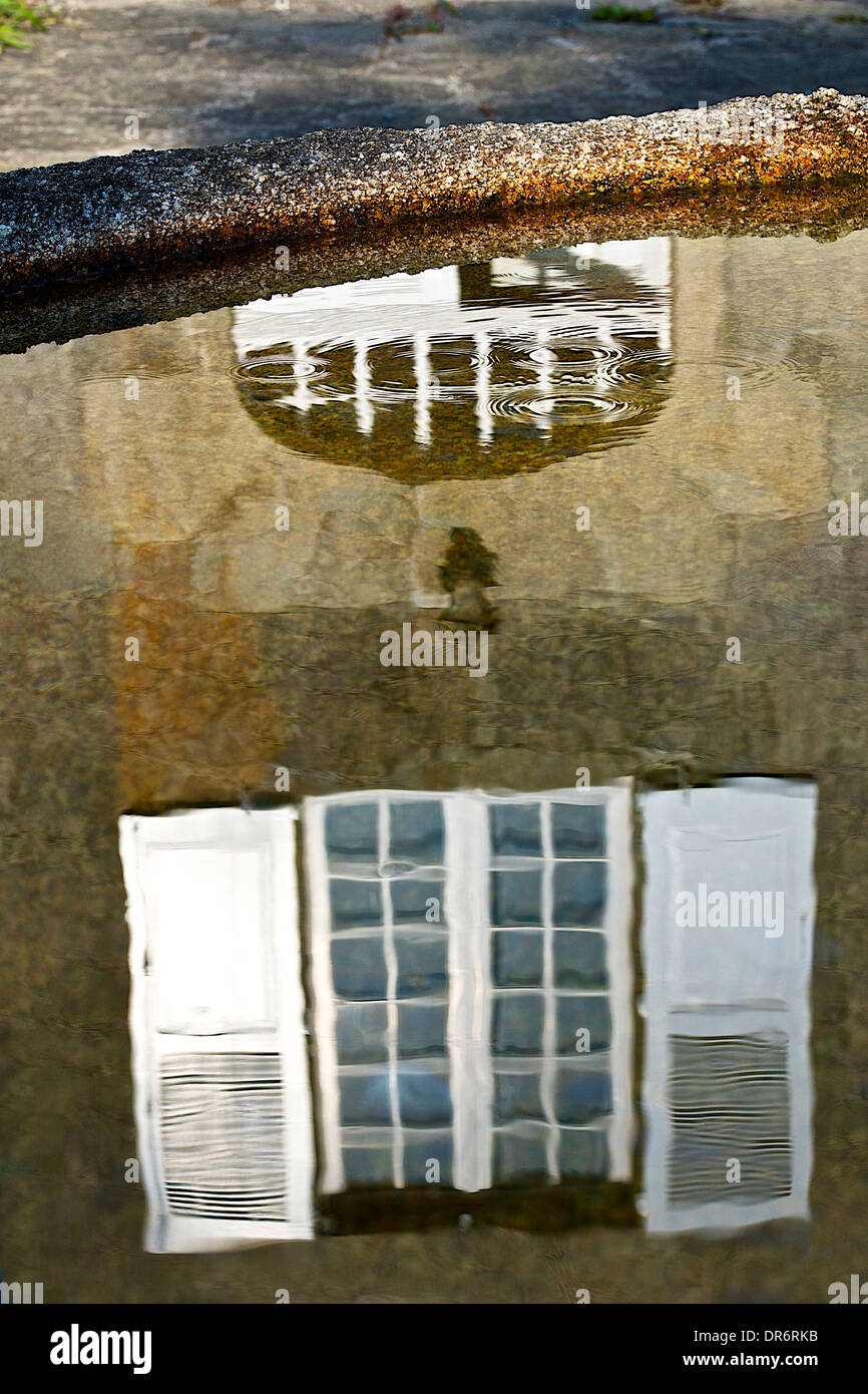 Window reflected on surface of fountain Stock Photo - Alamy