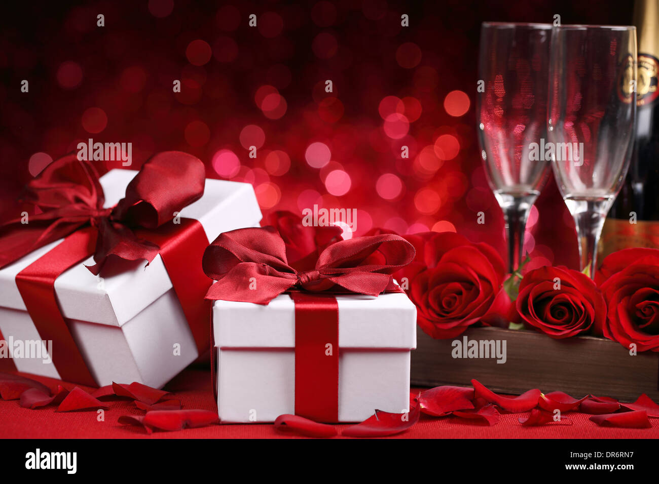 champagne,gift box and rose on red background Stock Photo - Alamy