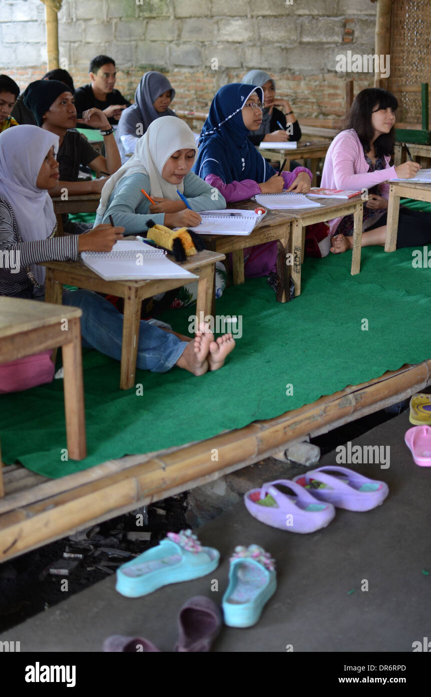Locals study English language during a class in the village of Pare ...
