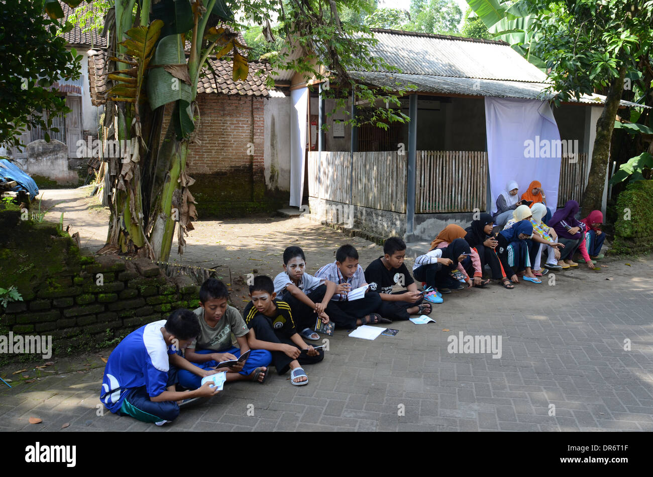 Some students studying English language in the street in the village of ...