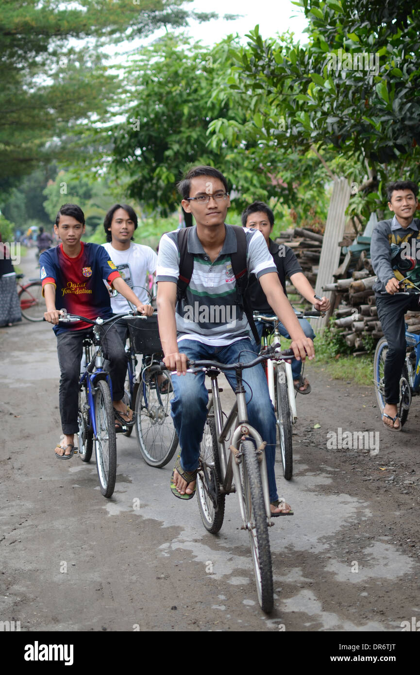 Some students riding bicycle in the village of Pare Stock Photo - Alamy