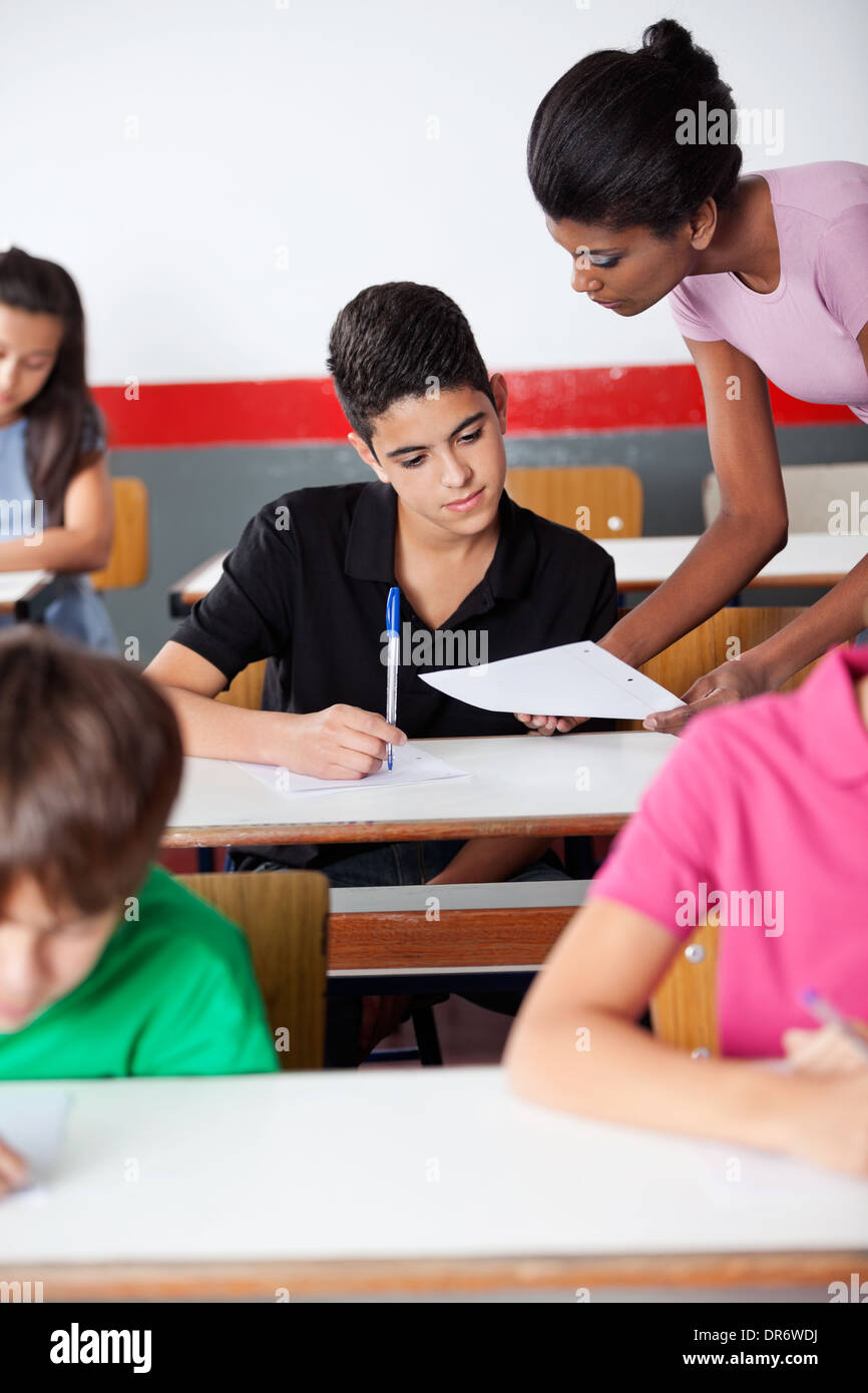 Teacher Showing Paper To University Student Stock Photo - Alamy