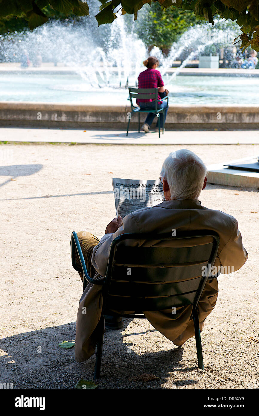Old man reading newspaper at Royal Park in Paris, France Stock Photo ...