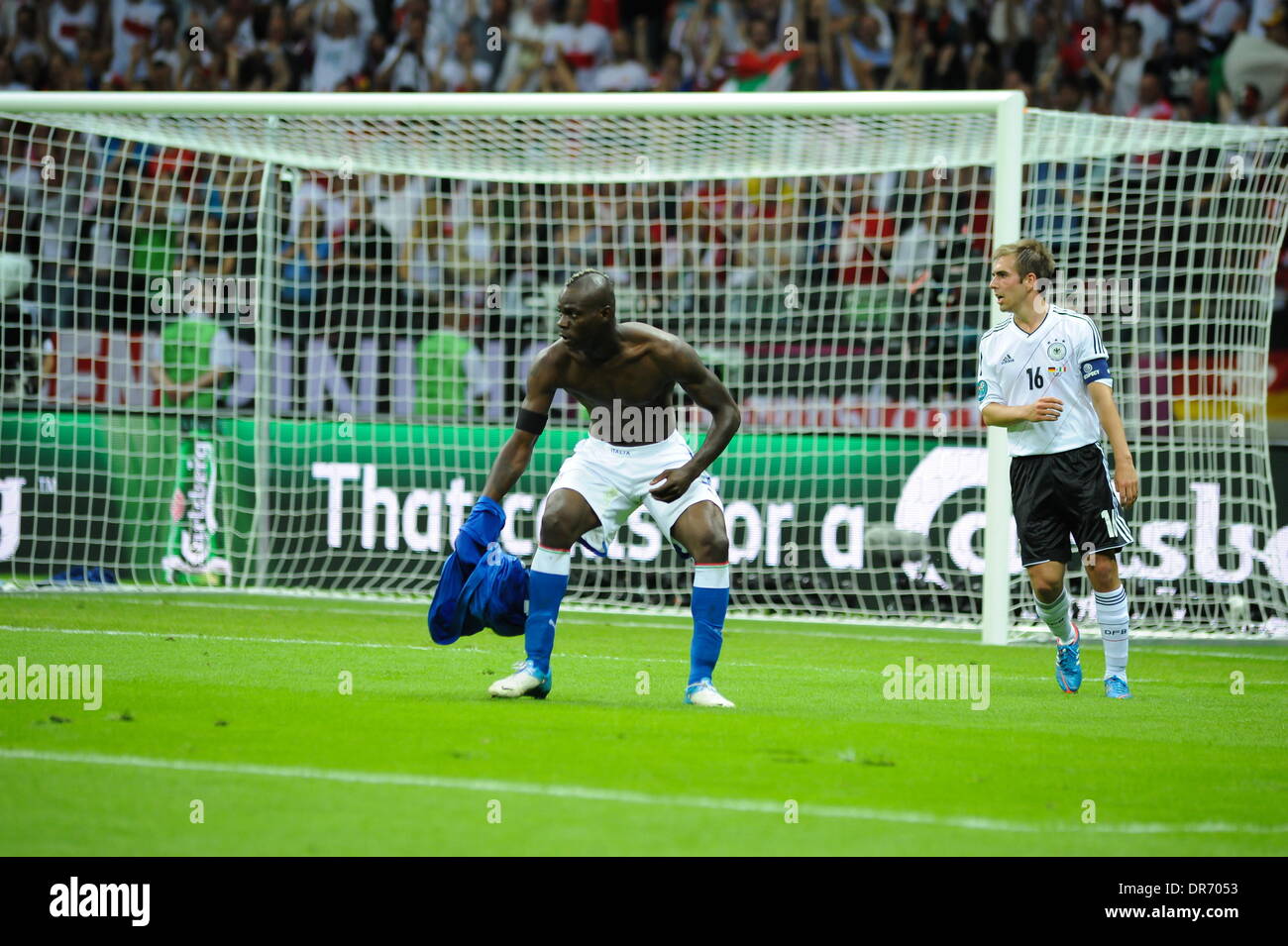 Mario Balotelli of Italy takes off his jersey after scoring his second ...