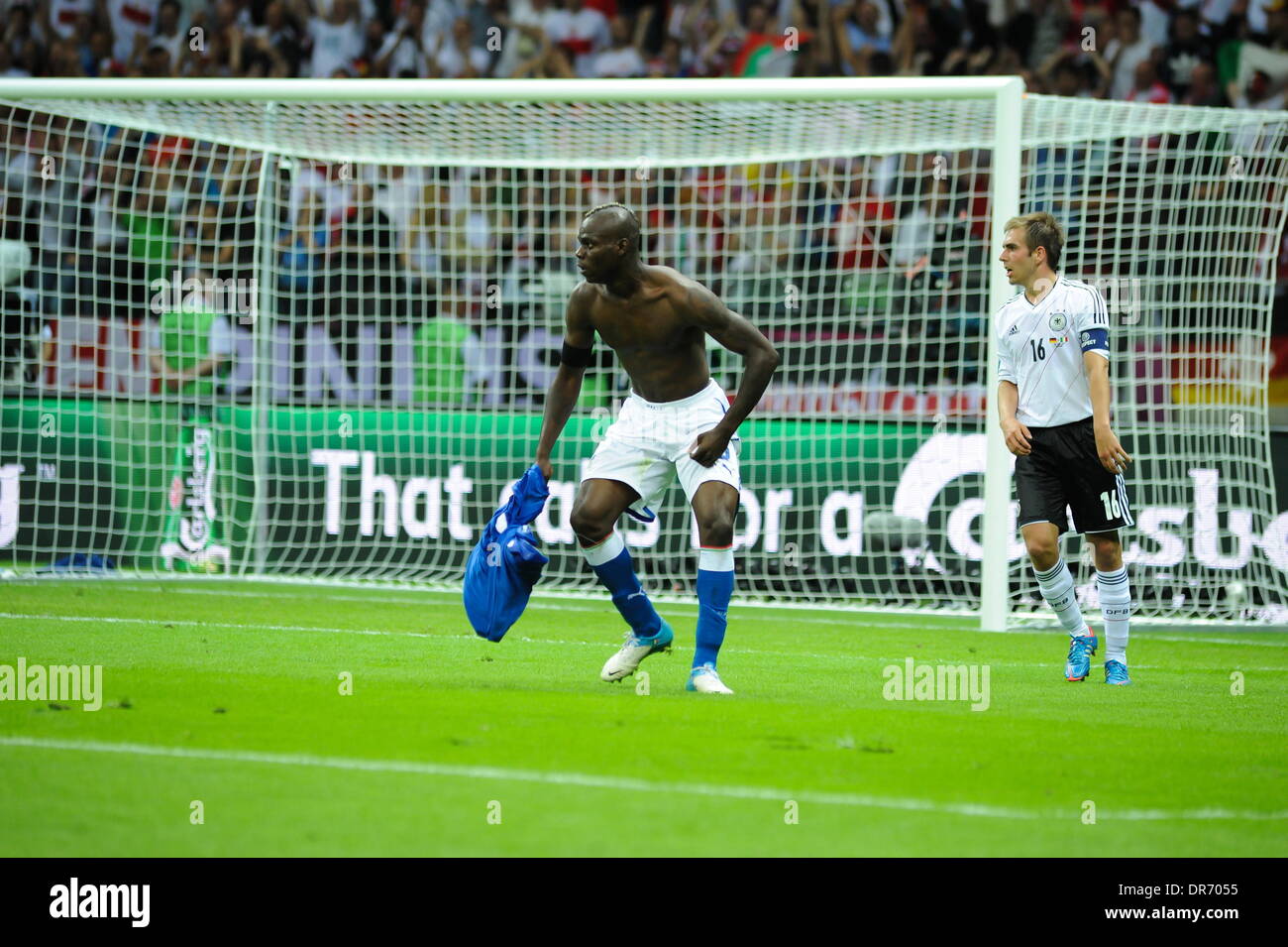 Mario Balotelli of Italy takes off his jersey after scoring his second ...