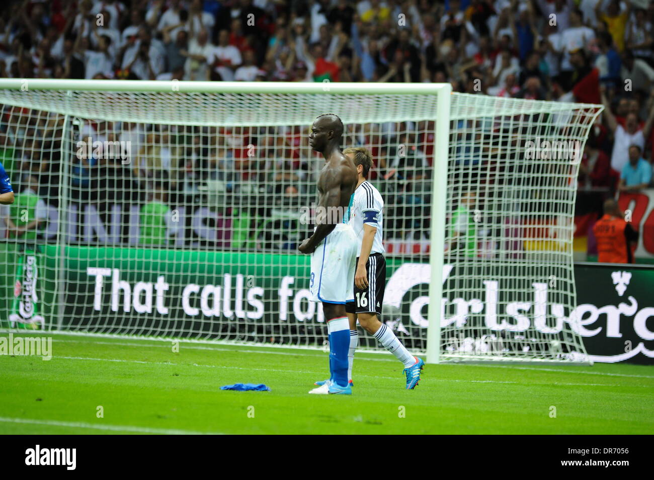 Mario Balotelli of Italy takes off his jersey after scoring his second ...