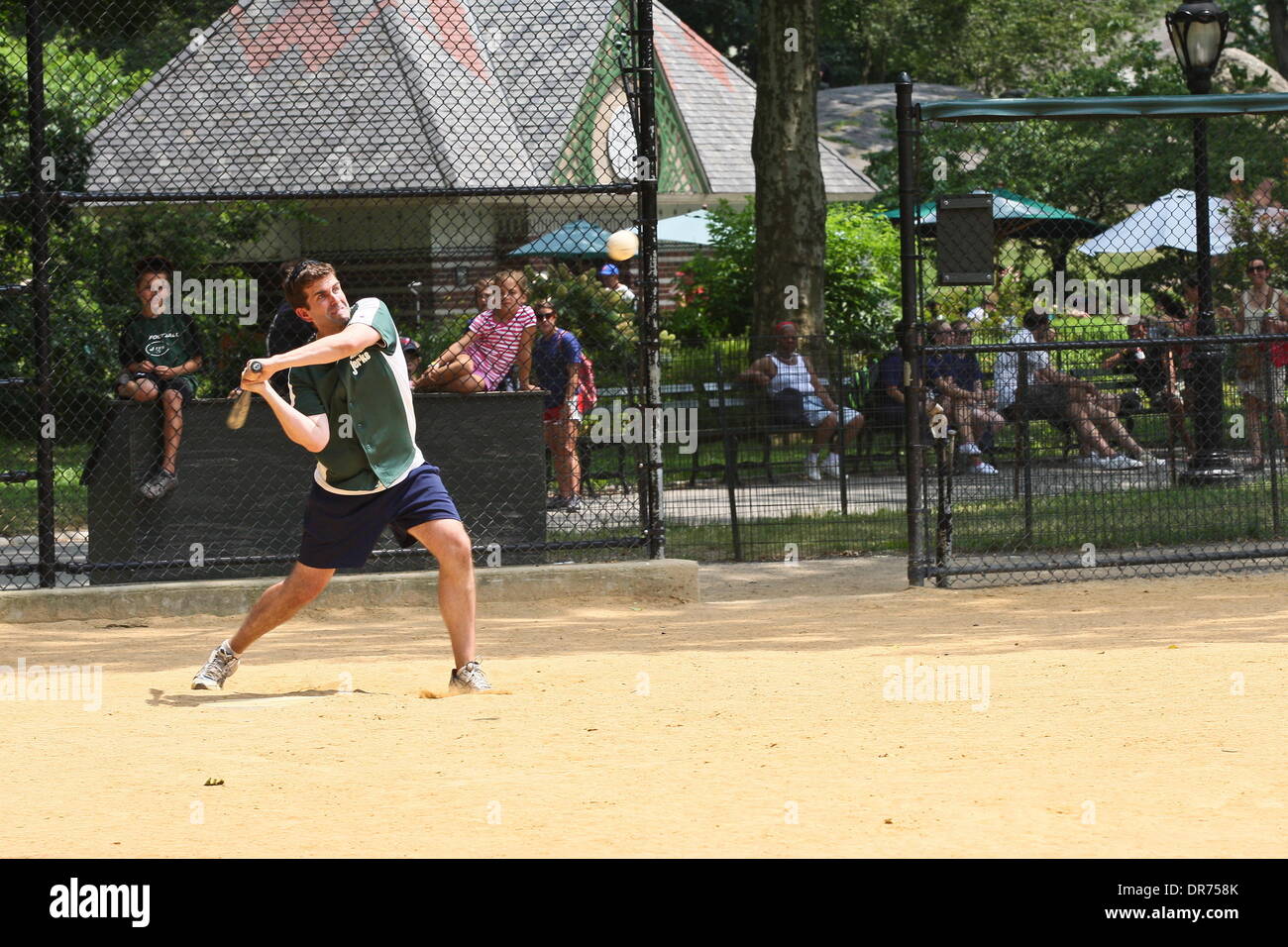 Atmosphere A man playing softball at Central Park, Manhattan. A heat ...