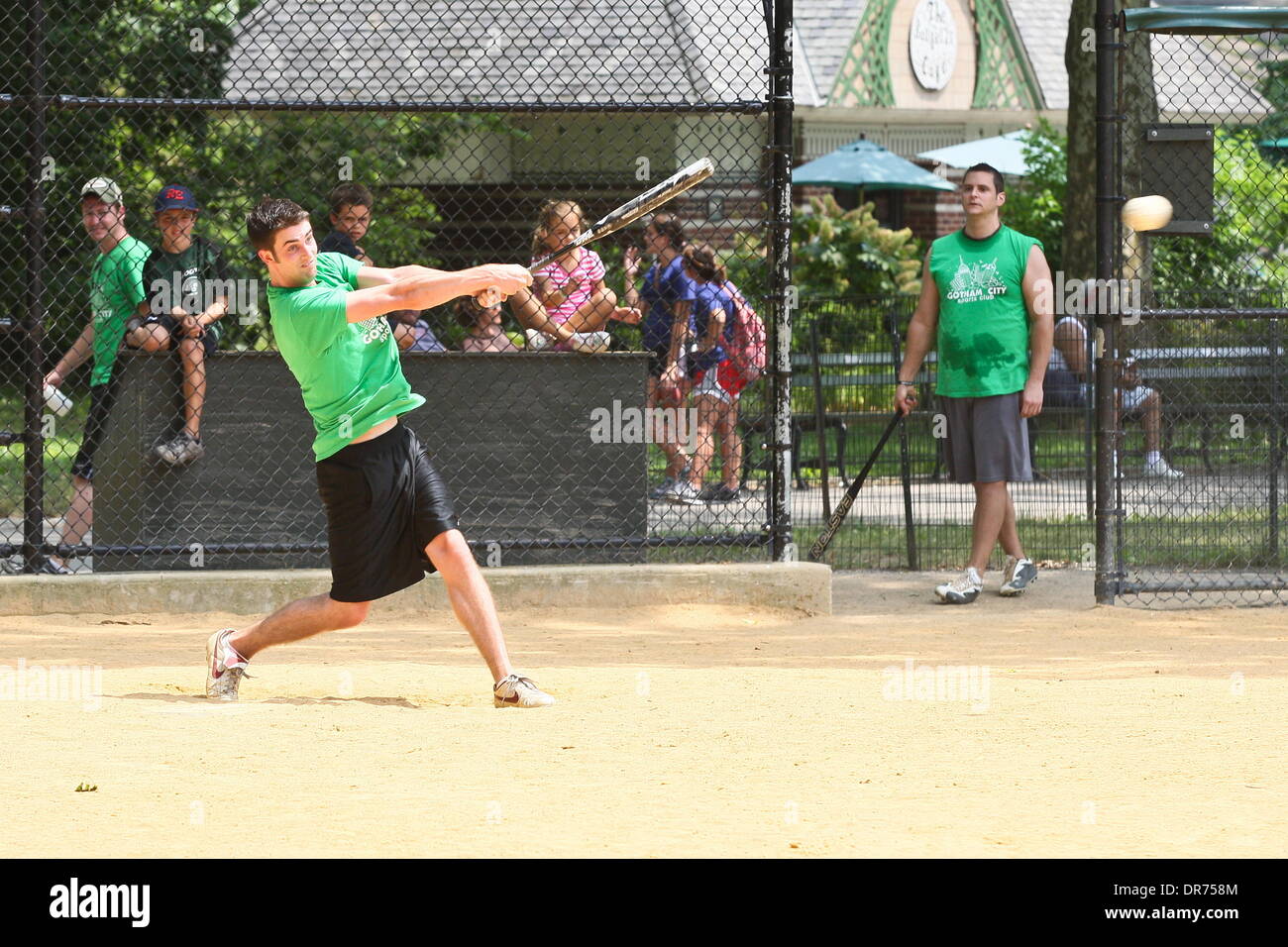 Atmosphere A man playing softball at Central Park, Manhattan. A heat ...