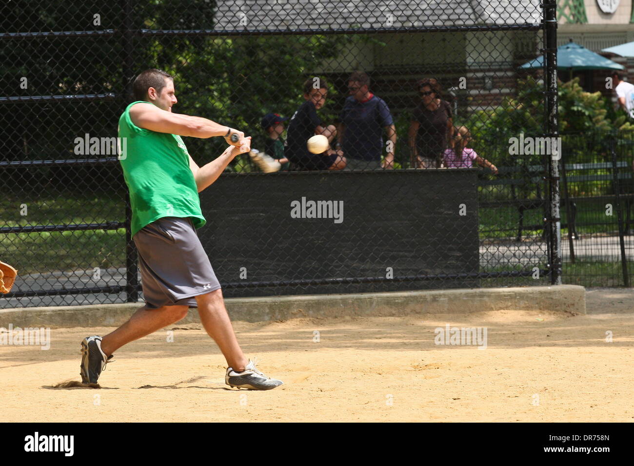 Atmosphere A man playing softball at Central Park, Manhattan. A heat ...