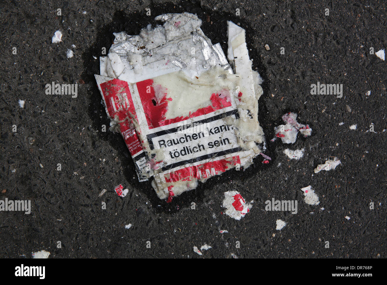 Squashed cigarette packet lying on the street, close-up Stock Photo - Alamy