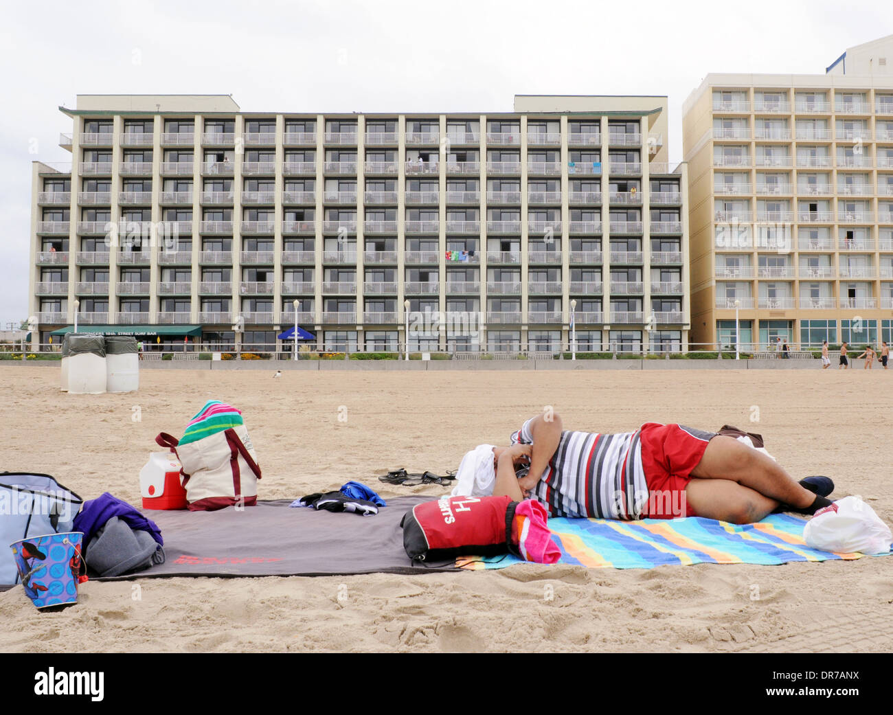A man takes a nap on VIrginia Beach, VA, USA Stock Photo - Alamy