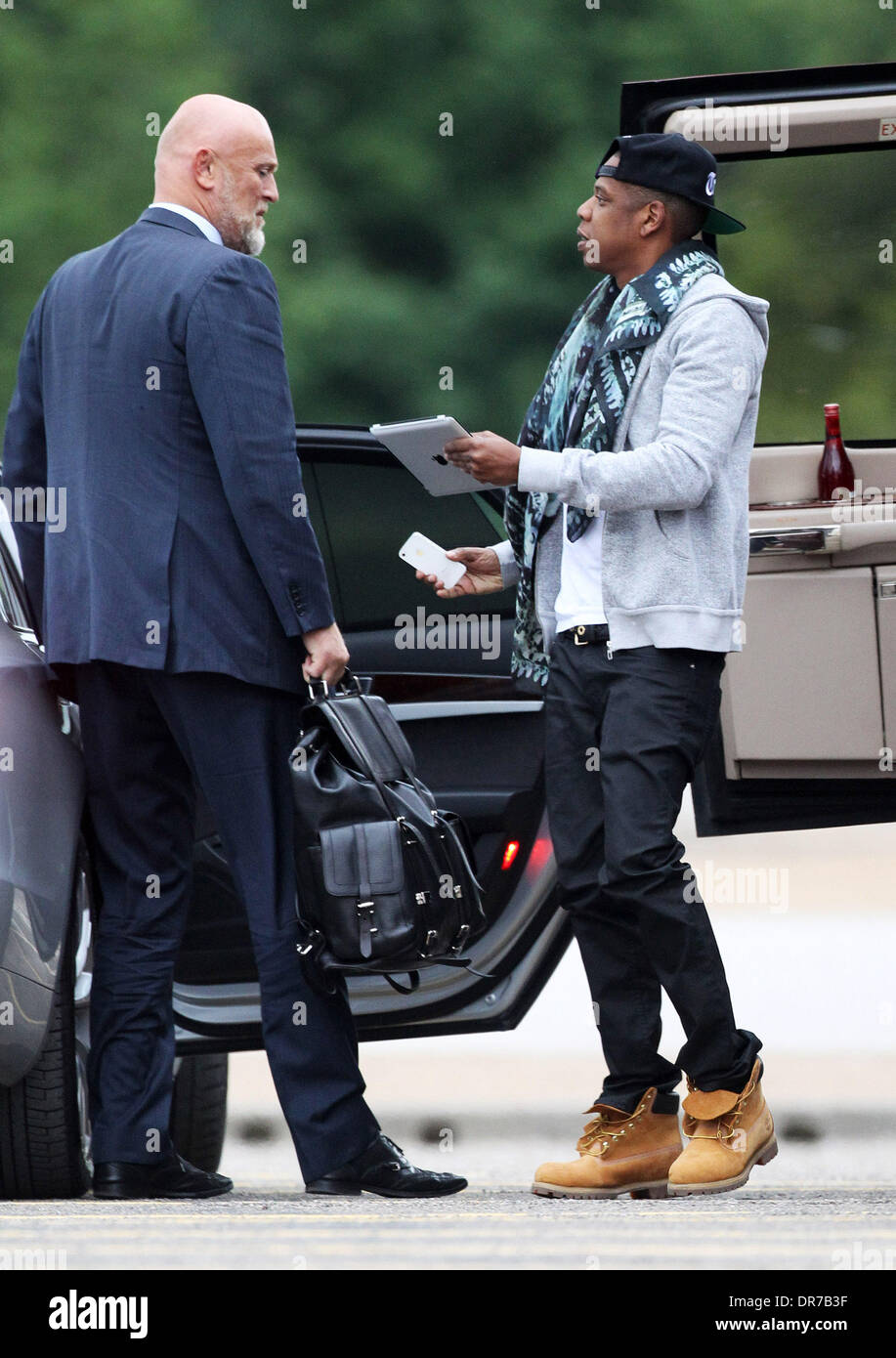 Jay Z clutches both an iPad and an iPhone as he flies into the car park ...