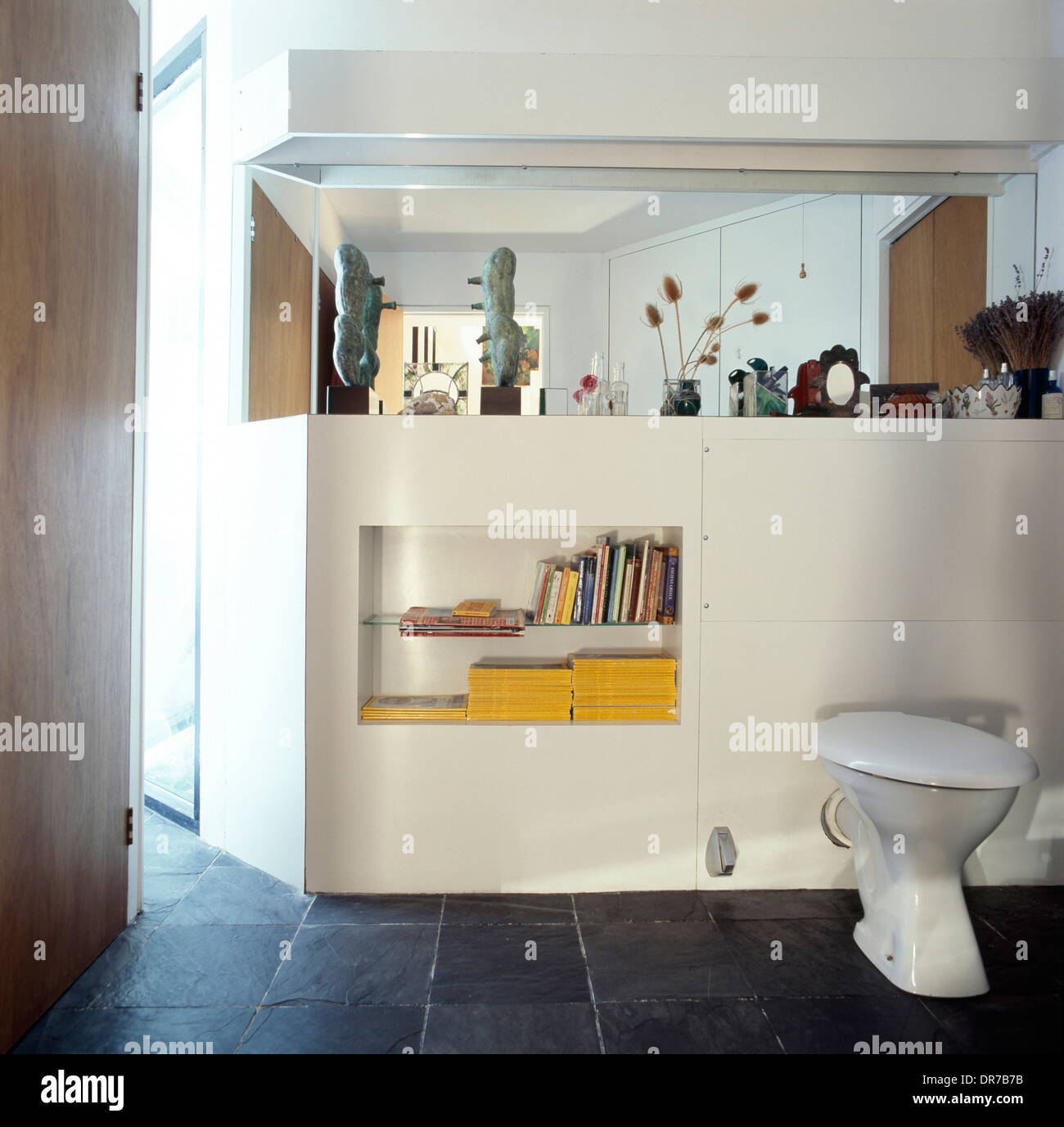 Cloakroom with white wc against white Formica panelling Stock Photo - Alamy