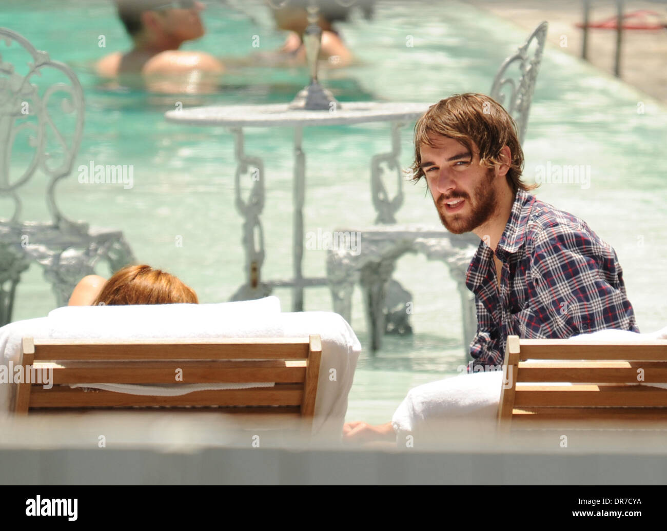 Miley Cyrus and Cheyne Thomas spend some time relaxing at the pool ...