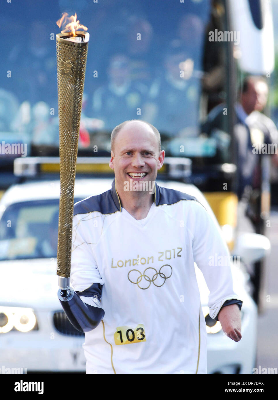 Amputee Jamie Andrew carries the Olympic Torch during the London 2012 ...
