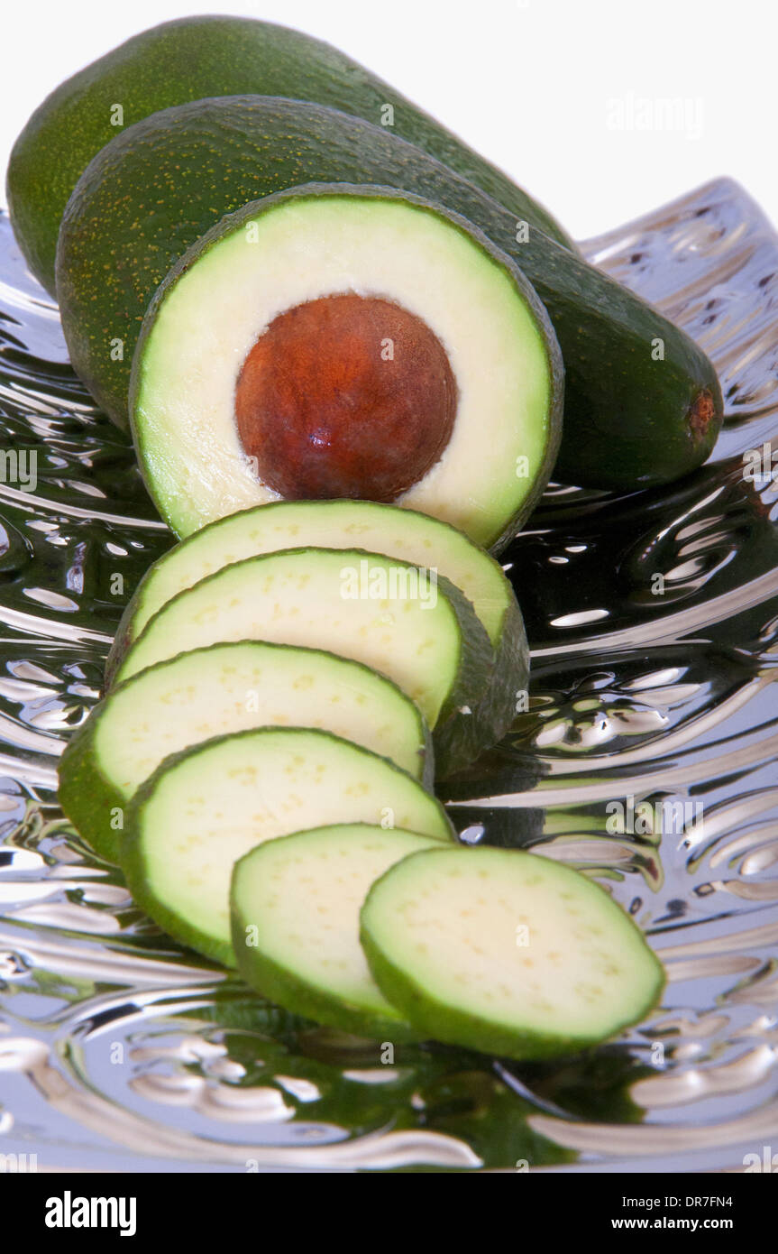 Green Avocado Pear Sliced in Circles on a Silver Plate Stock Photo - Alamy