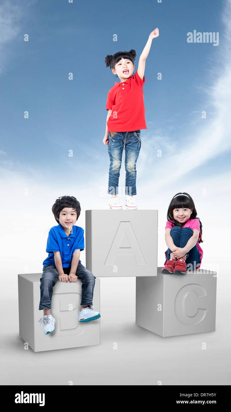 kids standing on blocks Stock Photo - Alamy